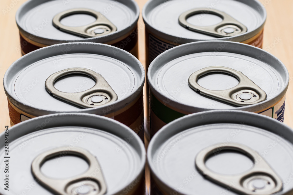 Stack of tin cans with a key. Condensation has formed on the cans ...