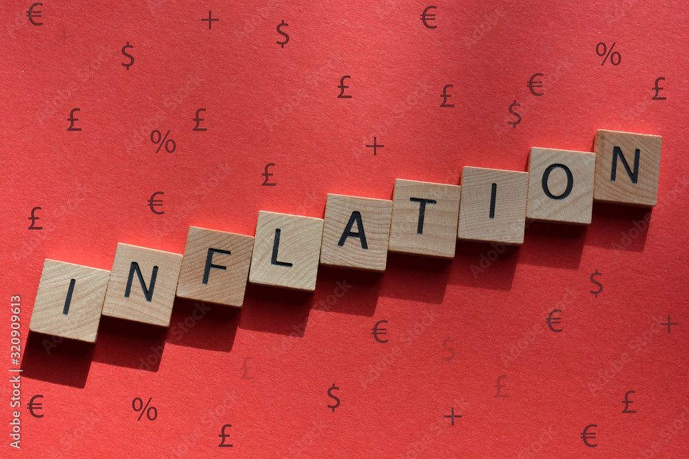 Inflation in 3 D wooden alphabet letters on a red background with money ...