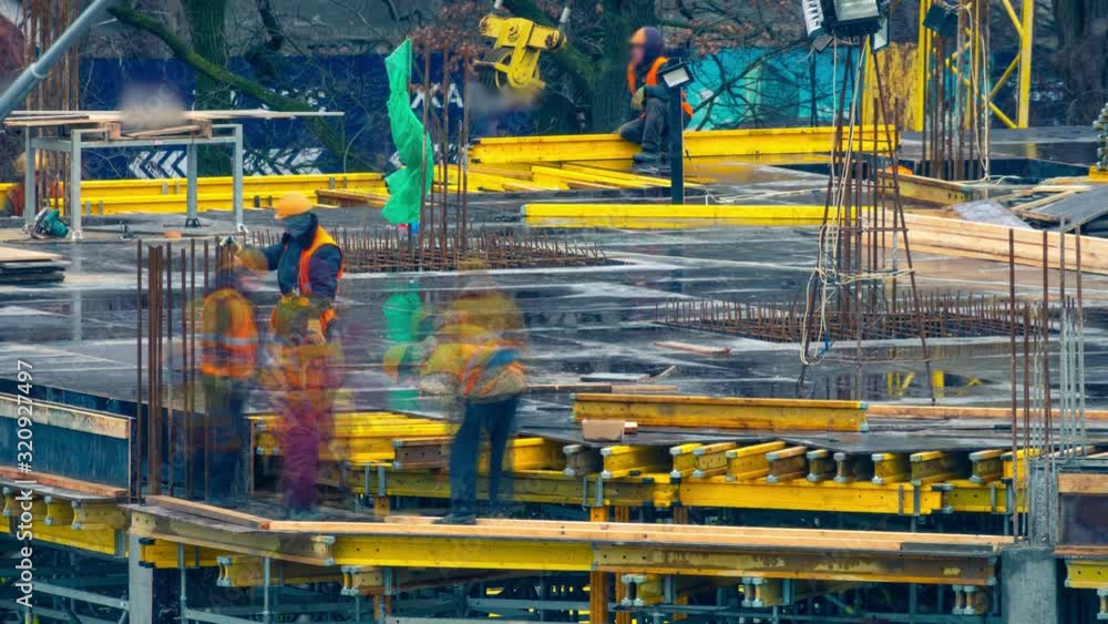 Group of construction workers at a construction site. Builders laying ...