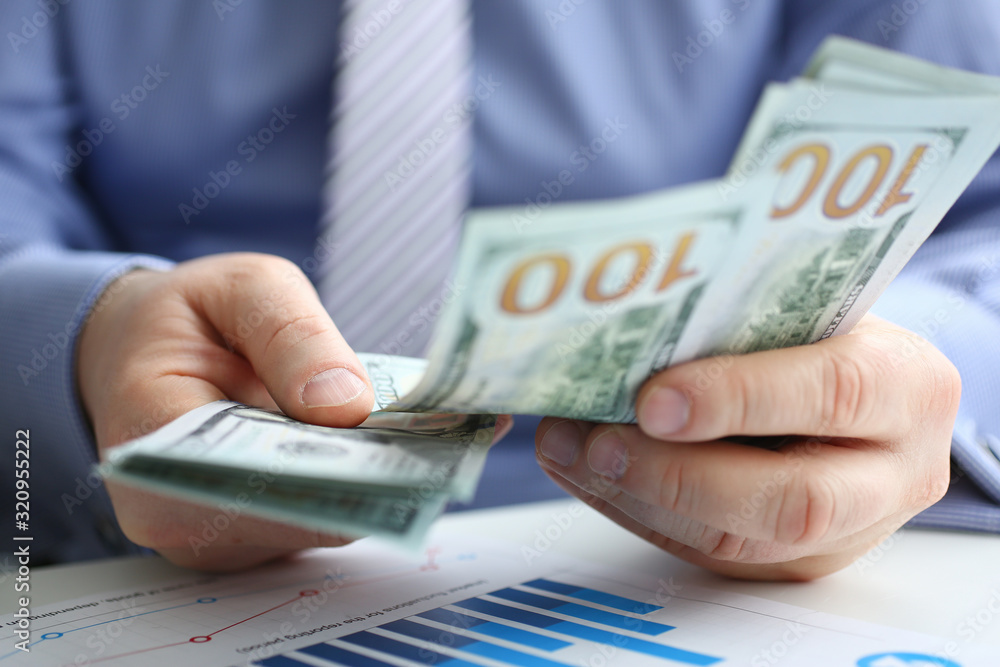 Businessman considers cash dollars in office issues salaries to ...