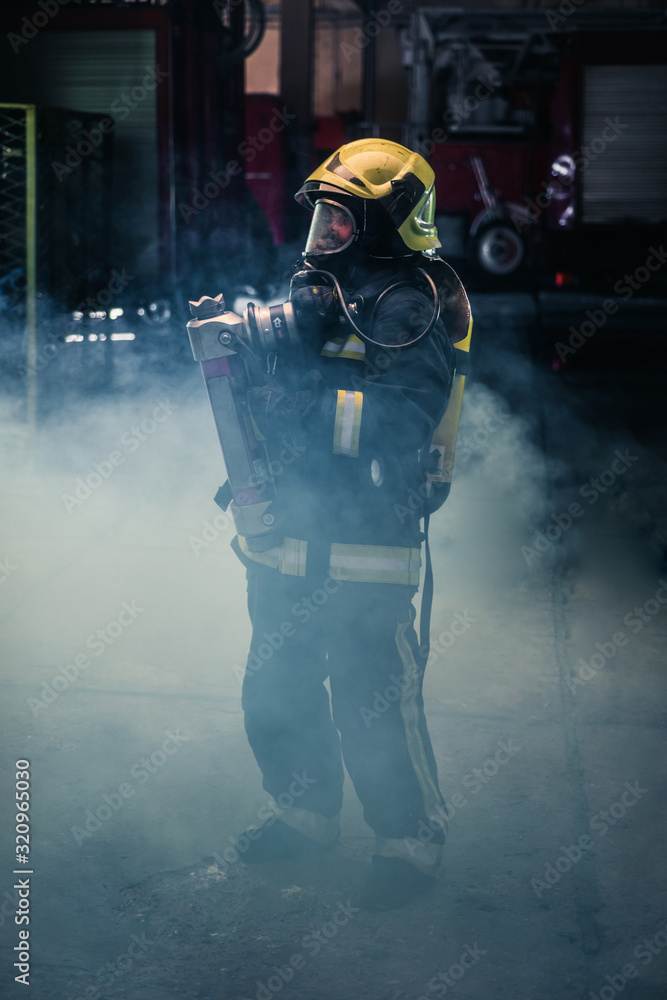 Portrait of a female firefighter wearing a helmet and all safety ...