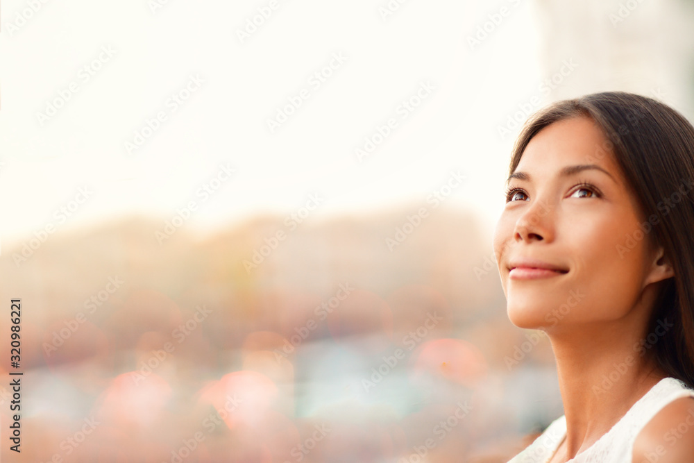 Happy young Asian woman natural beauty looking up pensive thinking of ...