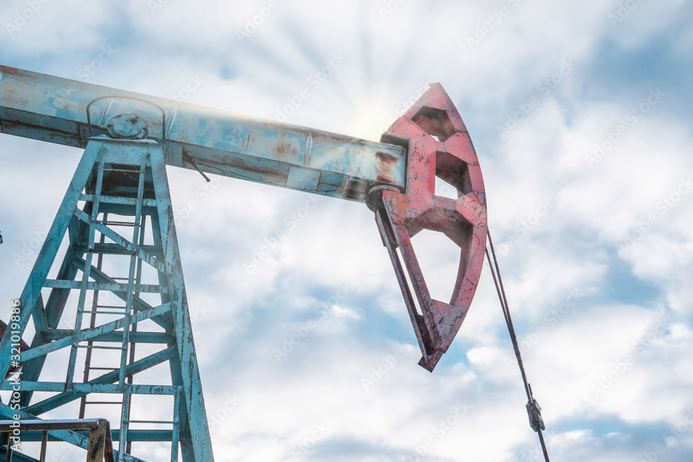 Oil pump jack rocking with pipeline in the background. Rocking machines ...