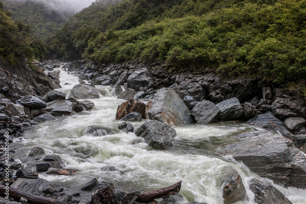 Stream. Creek. Rocks. Fast streaming water. Mount Aspiring National ...
