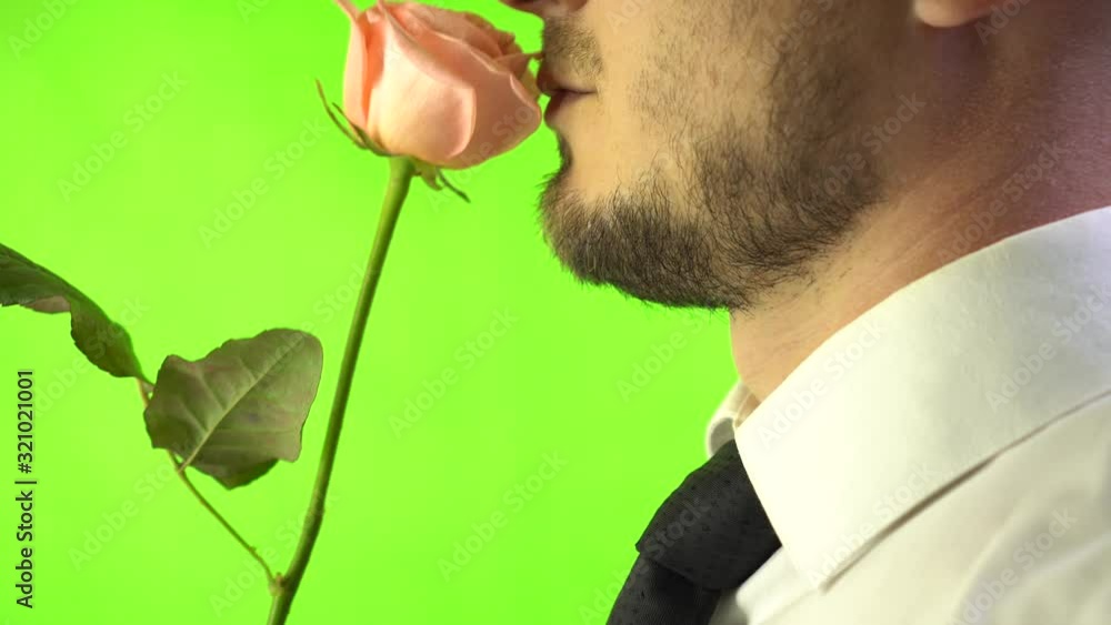 Close-Up Face Men Sniffing A Rose On Green Screen Background. Side view ...