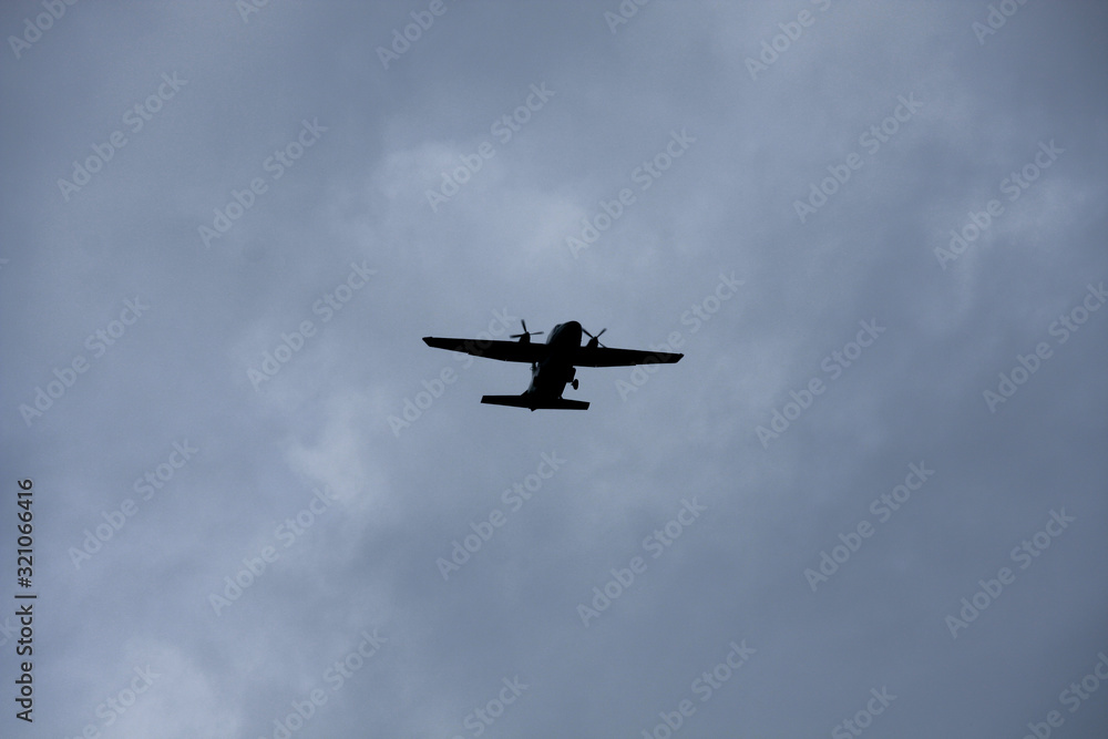 Silhouette two engine propeller airplane on sky, photoshoot from under ...