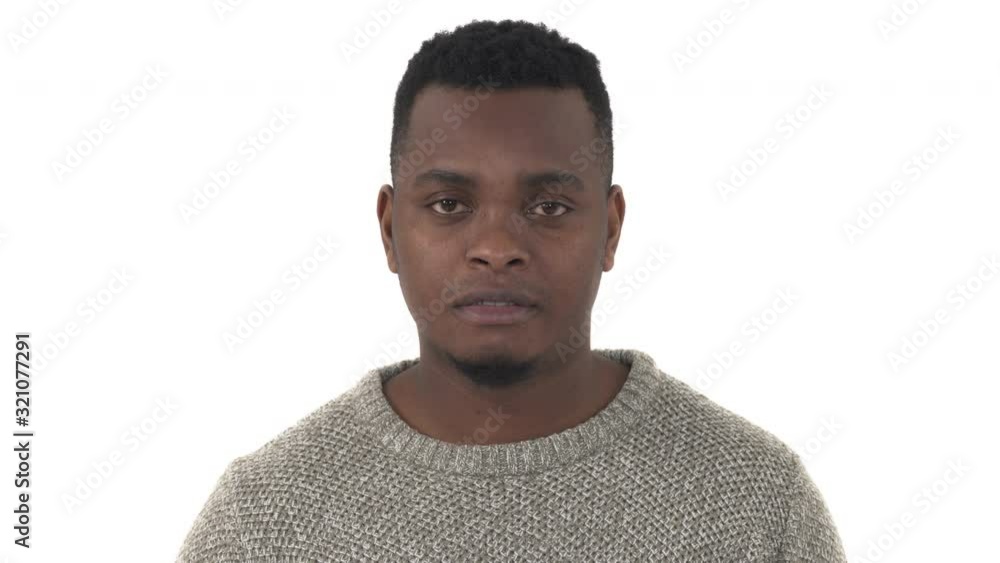 Handsome man winking his eye and showing hey you sign. Hand sign ...