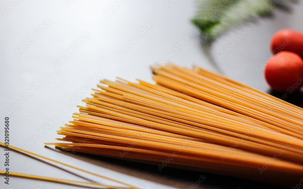 Yellow long spaghetti on a rustic background. Yellow italian pasta ...