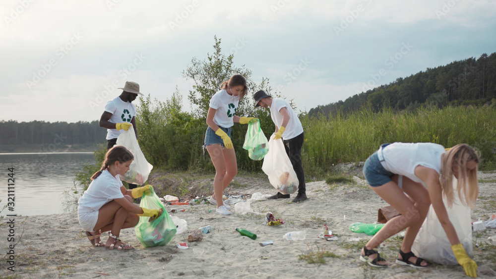 Save the planet. Team of vigorous recycling volunteers ccollecting ...
