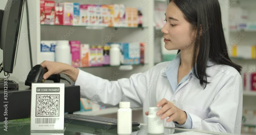 Customer using smartphone for scanning QR code for paying at drugstore ...