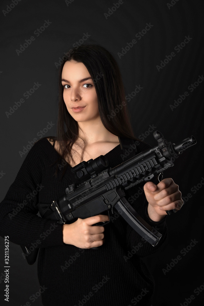 Female assassin with a gun Stock Photo | Adobe Stock