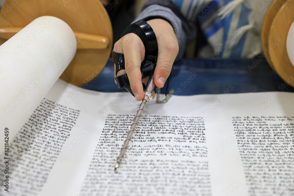 Boy Hand reading the Jewish Torah at Bar Mitzvah. Torah reading hand is ...