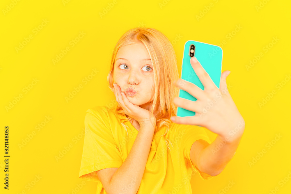 Smiling little girl kid showing blue screen of new popular mobile phone ...