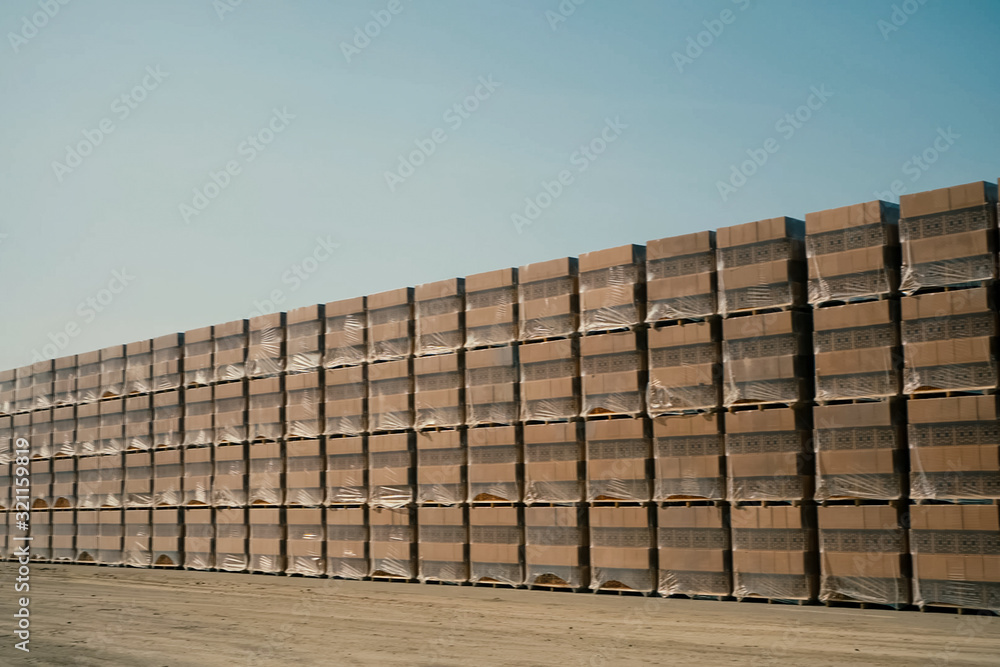 Bricks are stored in an open air warehouse. Red brick in pallets Stock ...