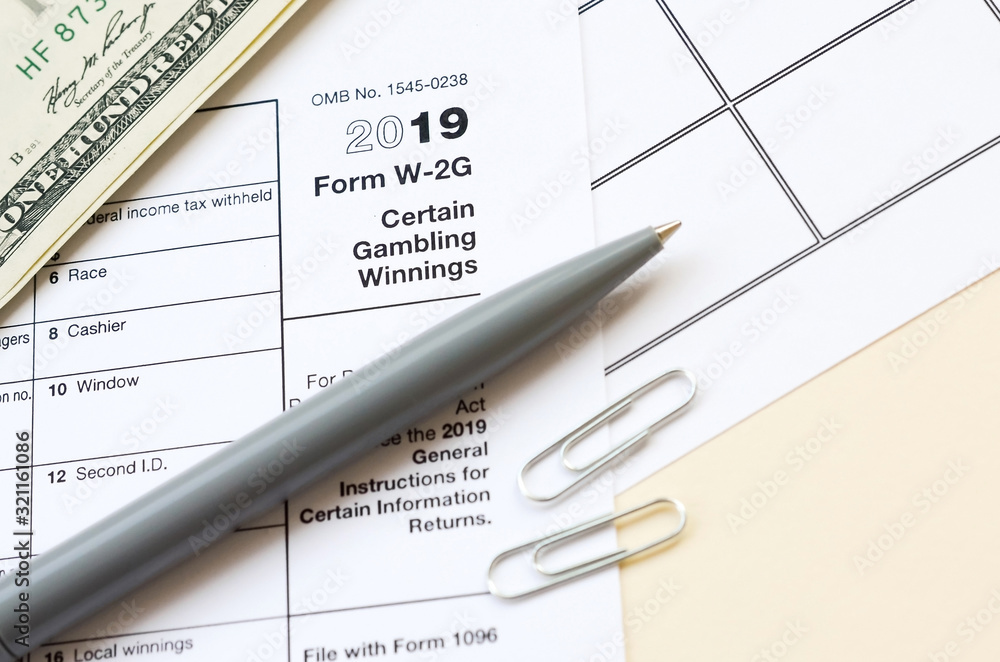 IRS Form W-2G Certain Gambling Winning blank lies with pen and many ...