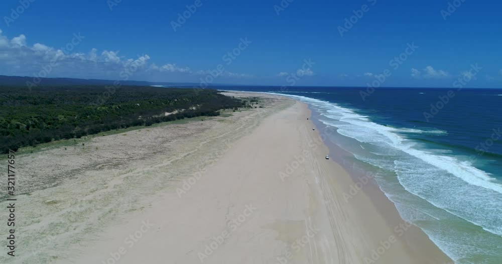 4k slow forward tracking aerial view of sandy coastal beach with 4 ...