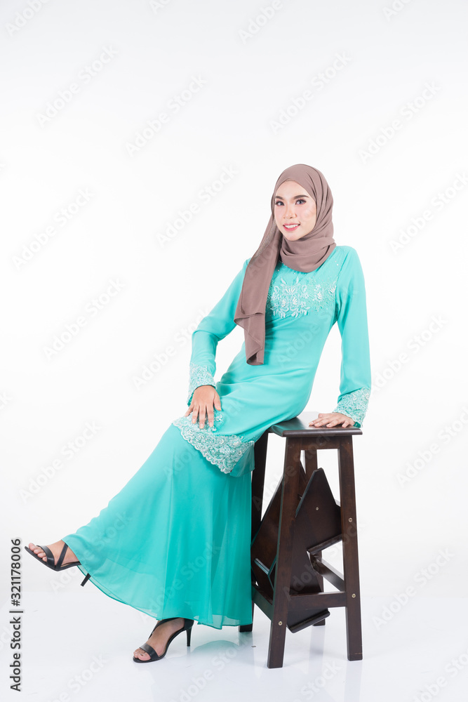 Beautiful female Muslim model in various poses wearing modern kurung ...