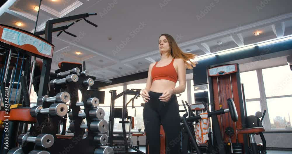 Female athletes in the gym. Group of attractive girls perform different ...