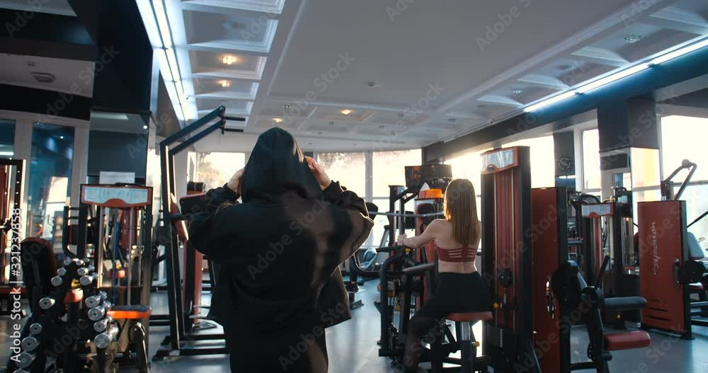 Female athletes in the gym. Tracking shot between the rows of ...