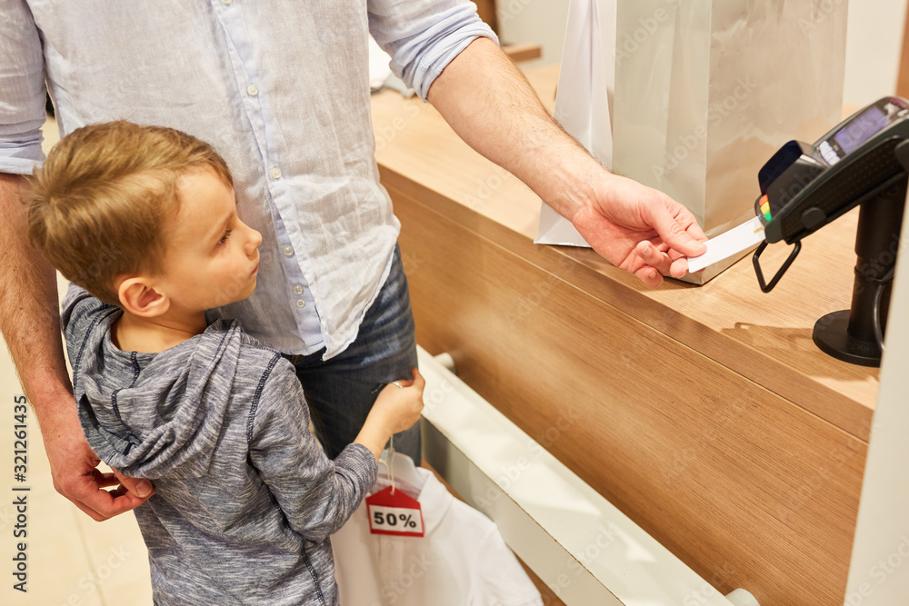 Father and child pay by credit card Stock Photo | Adobe Stock