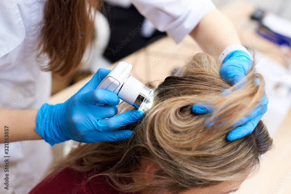 Microscopic examination of the hair and skin of the scalp. Stock Photo ...