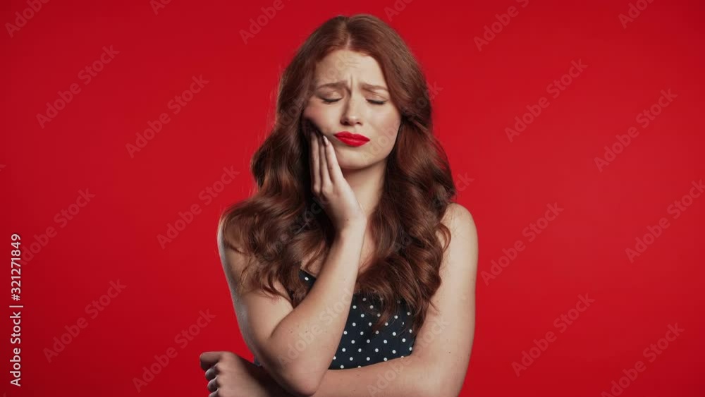 Young pretty woman with tooth pain on red studio background. Toothache ...