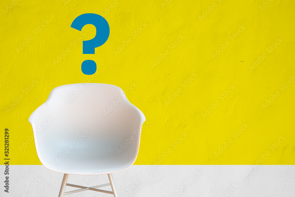 Chair in a waiting room of a hiring office in front of a yellow wall ...