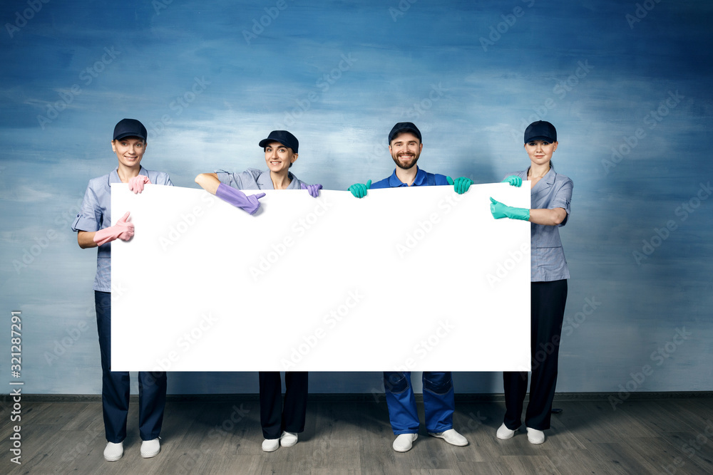 A man with a beard and young women in clothes of cleaners and rubber ...