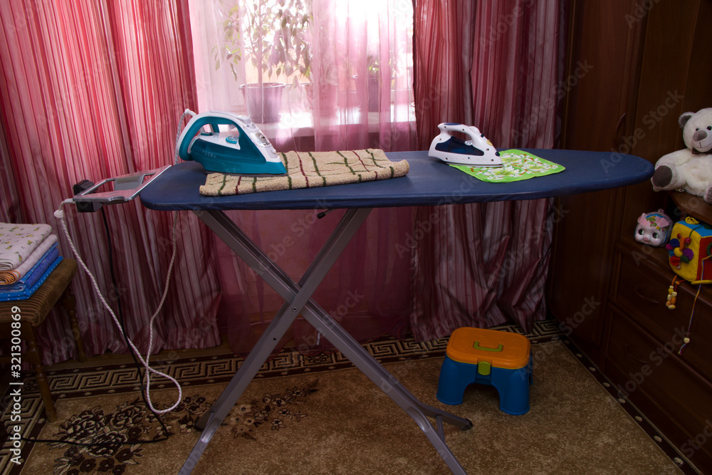 Household chores and children. Like a woman ironing clothes when ...