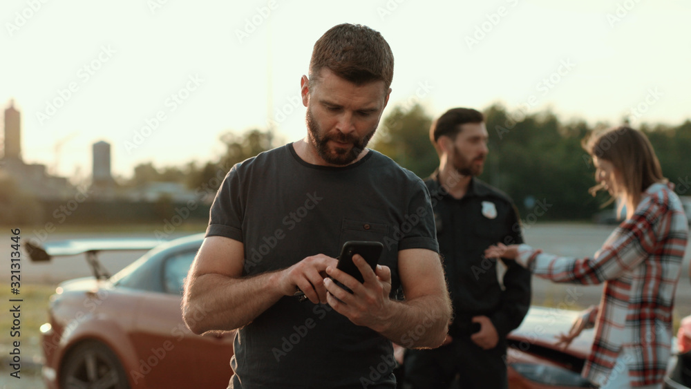 Portrait of angry baffled man with beard tapping on smartphone ...