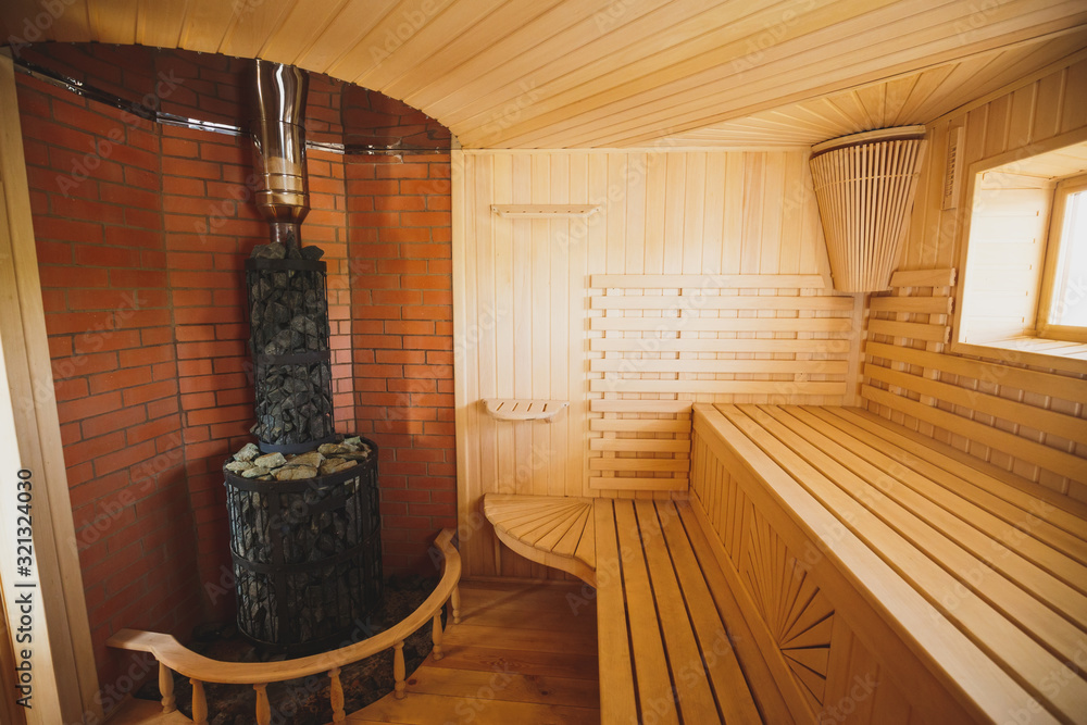 Light, spacious sauna made of natural wood with a sauna heater Stock ...