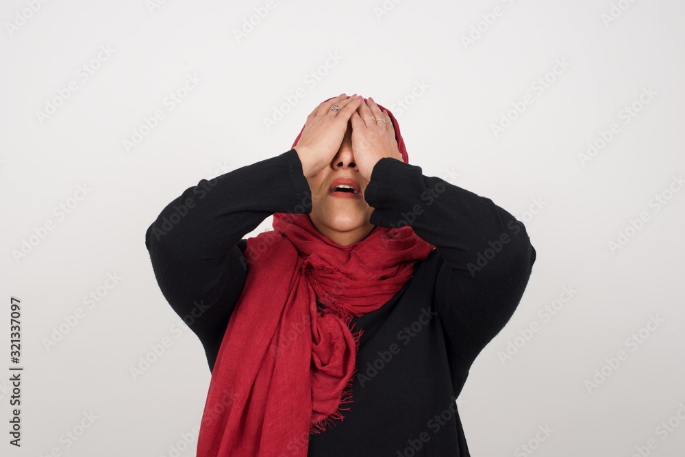 Shocked panic muslim woman dressed in stylish clothing holding hands on ...