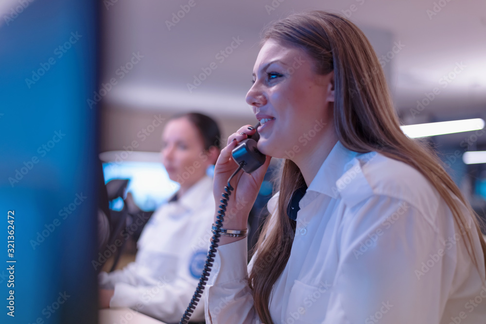 Security guard monitoring modern CCTV cameras in a surveillance room ...