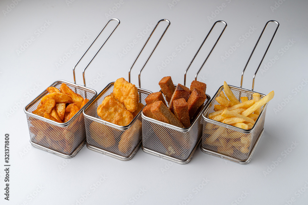 Set of hot deep fried beer snacks: crispy chicken nuggets, french fries ...