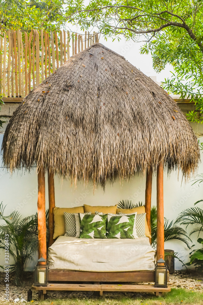 Straw hut bed to relax in backyard at an AirBnB after a day at the ...