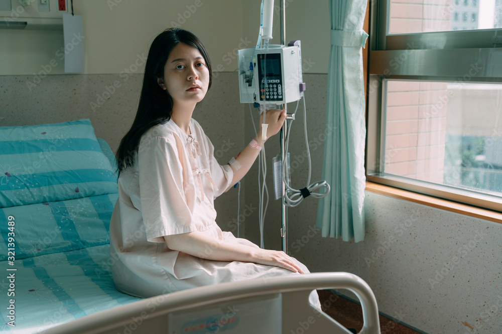 Saline in hands of female patient. illness asian japanese woman sitting ...