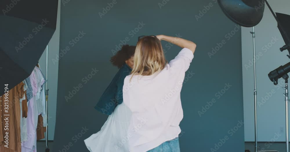 Young professional studio photographer taking photos of an african ...