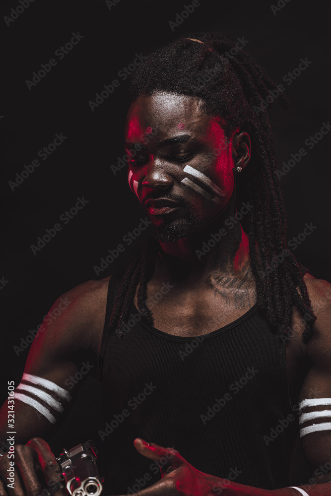 portrait of serious confident muscular black man isolated over black ...