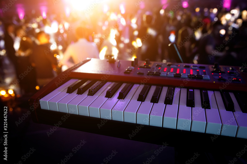 Piano keys in purple light on concert stage. Synthesizer. Stock Photo ...