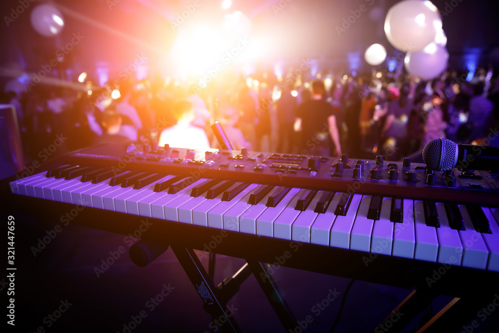 Piano keys in purple light on concert stage. Synthesizer. Stock Photo ...
