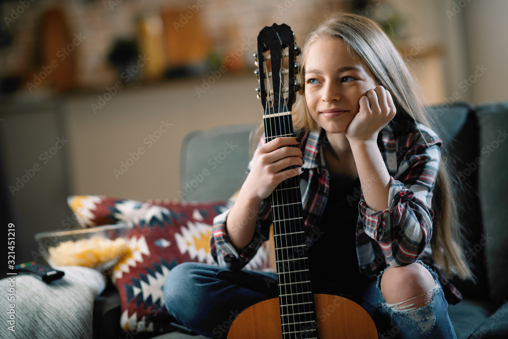 Cute little girl playing guitar. Teenage girl learning to play guitar ...