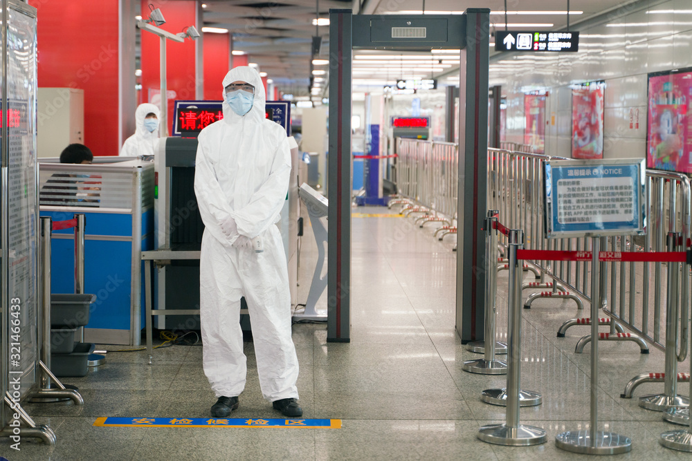 The security guard is staying on the front of subway entrance ...