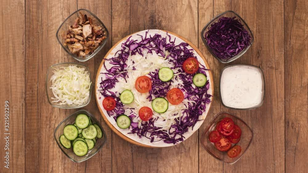 Making a kebab or gyros - a traditional roll sandwich wrapped in wheat ...