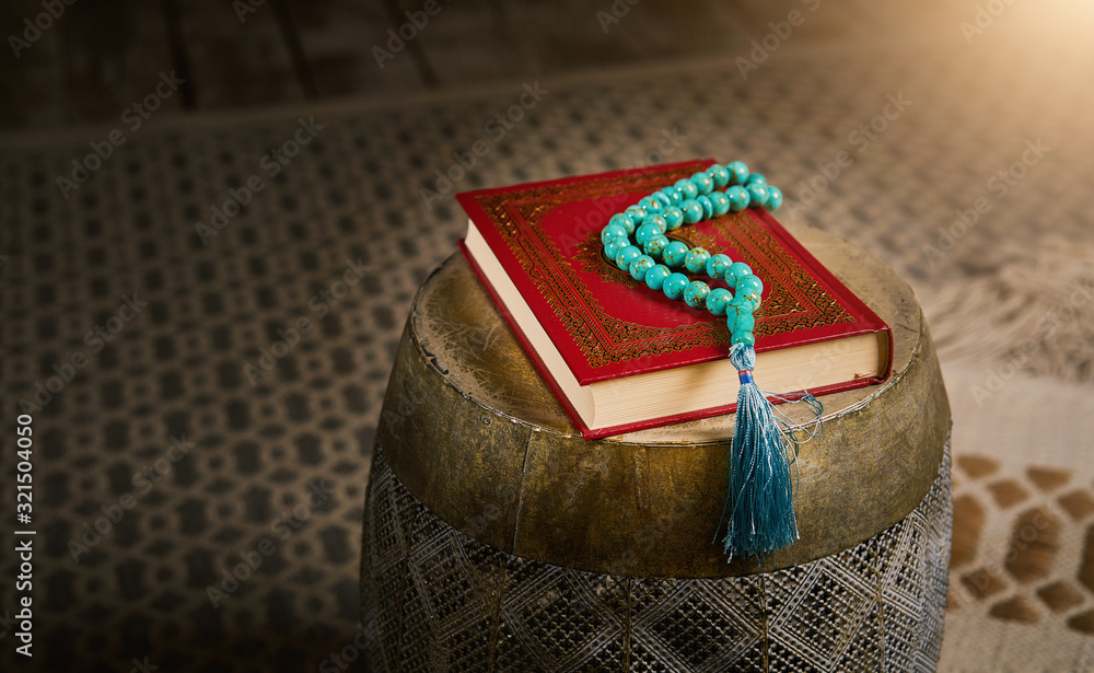 Islamic holy book Koran with rosary beads, muslim faith Allah and ...