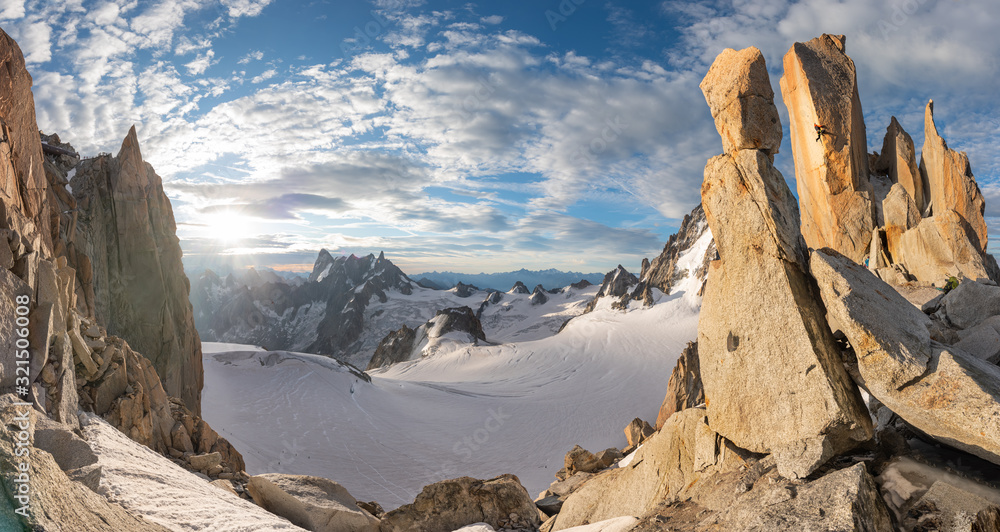 Mountain climber climbing the famous Cosmiques Arete in the French Alps ...