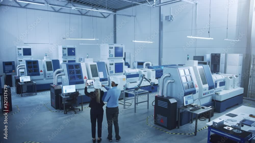 Modern Factory: Two Engineers Use Digital Tablet Computer with ...