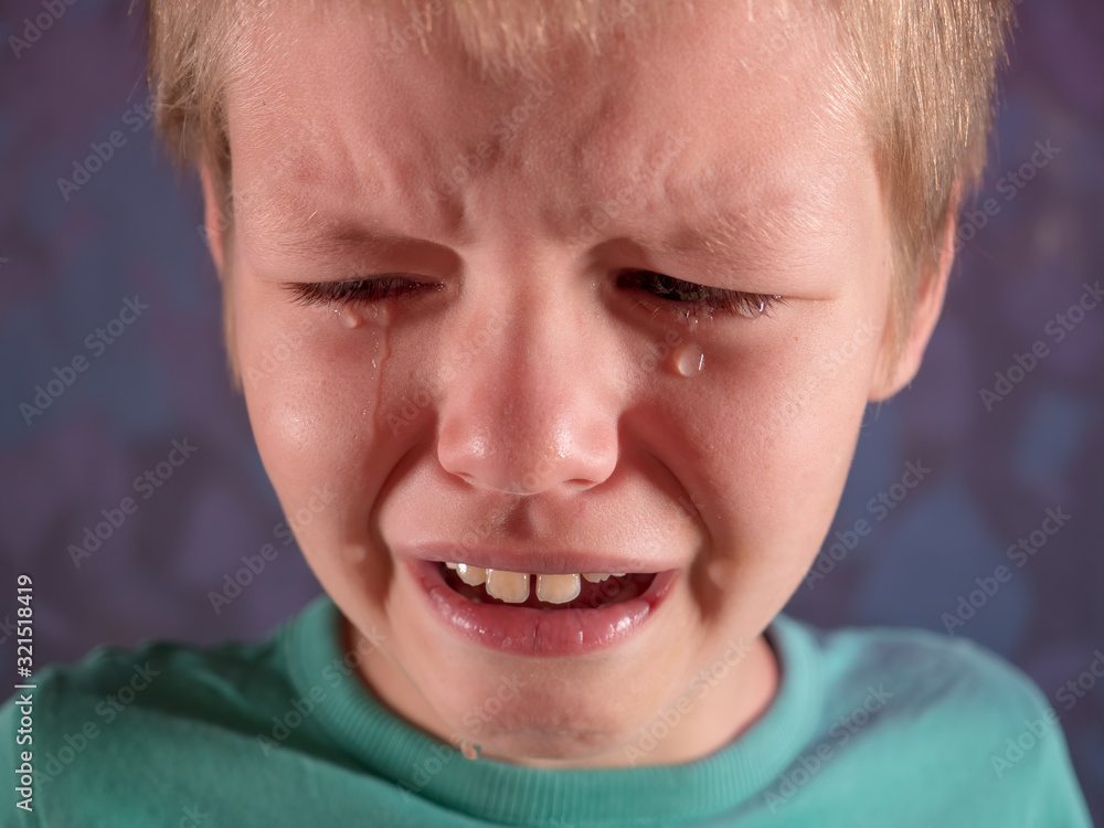 Face of crying boy close up. Eyes, eyelashes, eyebrows, lips, teeth and ...