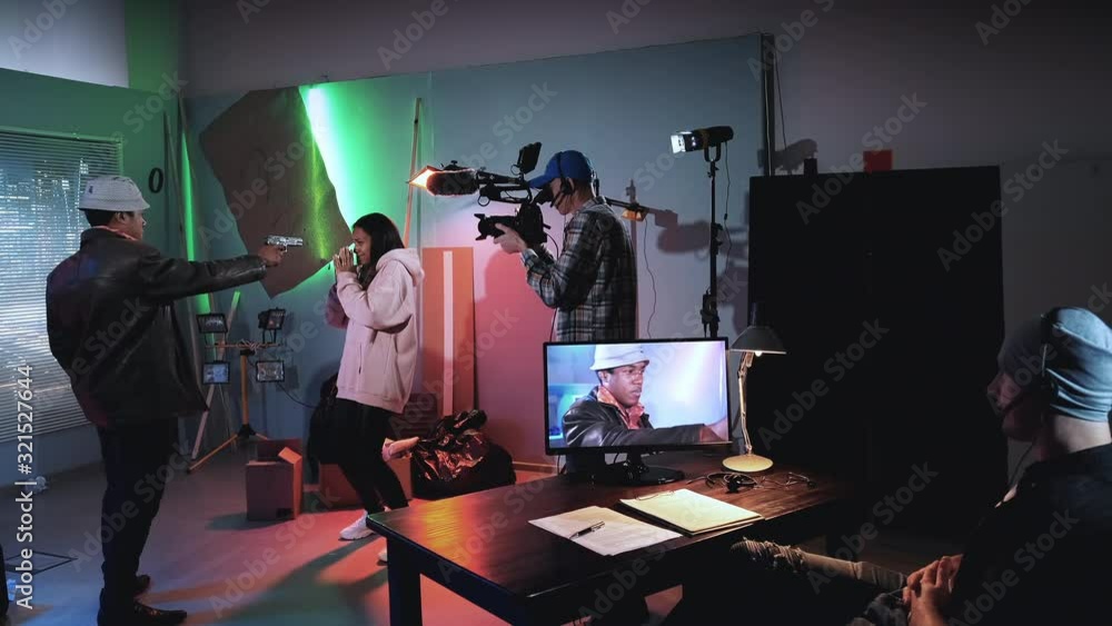 Dolly shot of Backstage of thriller film shooting: black man trying to ...