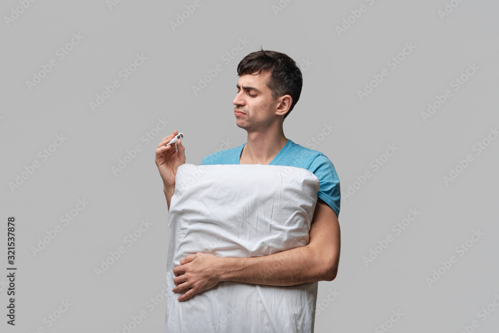 Young brunet man upset checking temperature because he cought cold ...