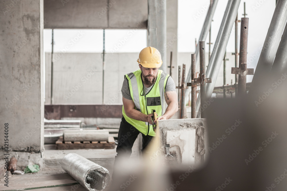 Construction worker working in construction site Stock Photo | Adobe Stock
